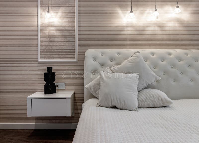 Bright Bedroom with Large White Bed and Capitone Headboard Stock Photo ...