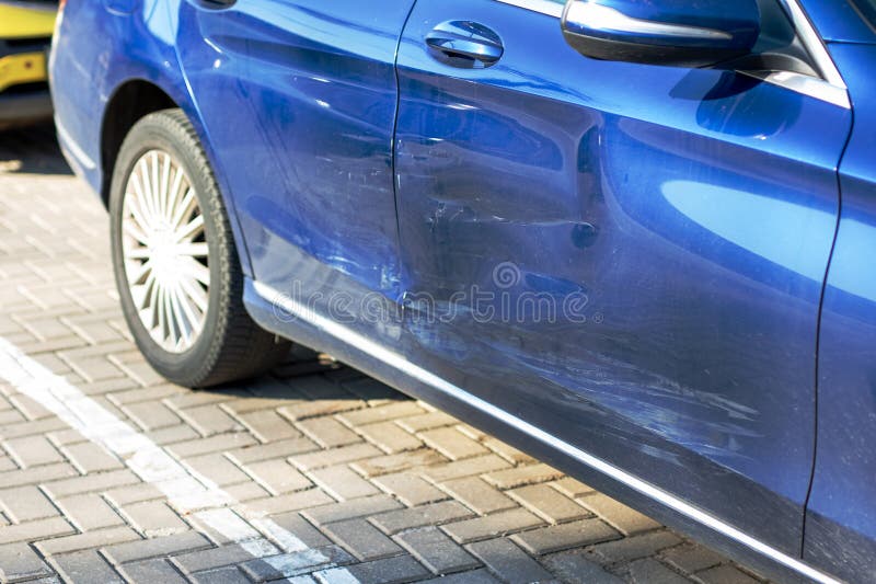 A Bright Blue Car is Parked and Resting on a Brown Brick Pavement Stock ...