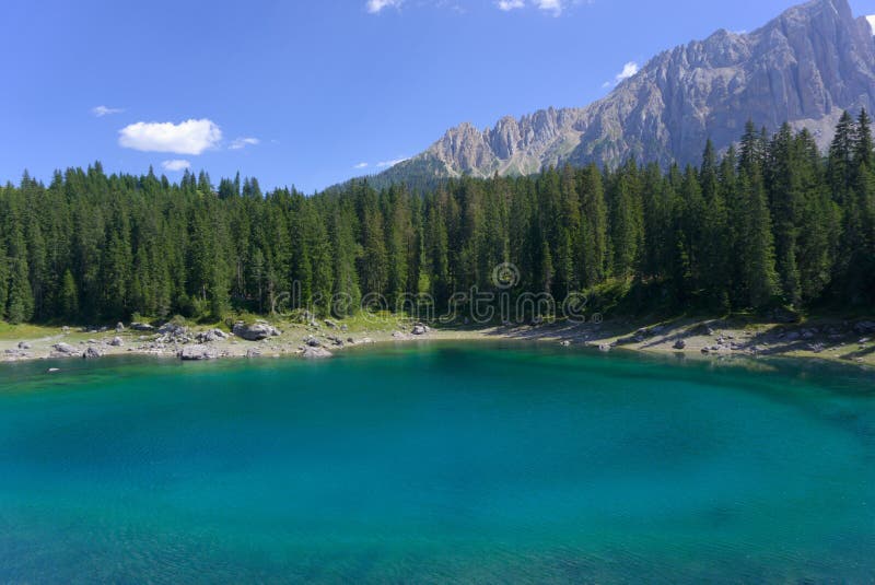 Bright Blue Lake with a Forest and Mountains in the Background Stock ...
