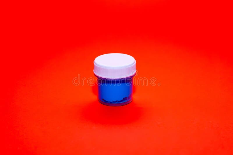 Bright Blue Paint in a Container on a Vivid Red Background Stock Photo ...