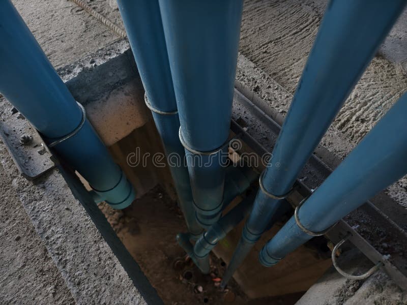 A Bright Blue Pipes Attached To a Solid Concrete Wall Stock Photo ...