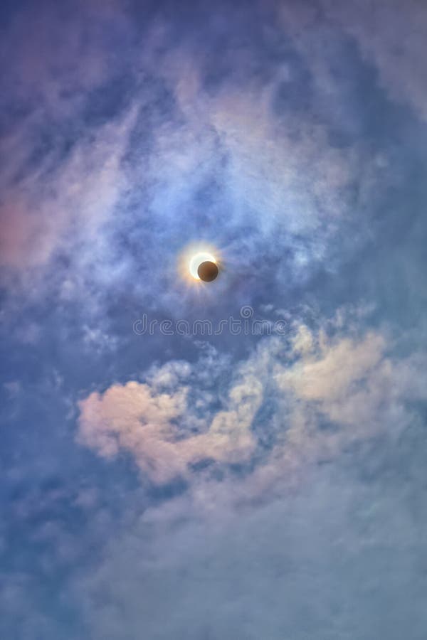 Bright Blue Sky with Clouds and a Solar Eclipse Stock Photo - Image of ...
