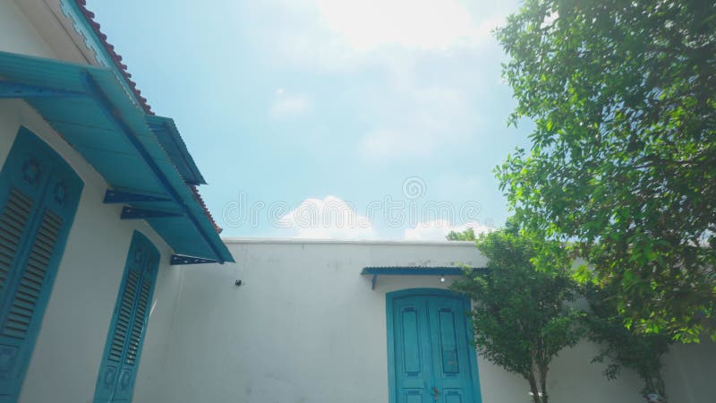 Charming White Building with Turquoise Accents Stock Video - Video of ...