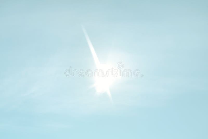 Bright Blue Sky with Light Clouds and the Sun in the Middle with Flares ...