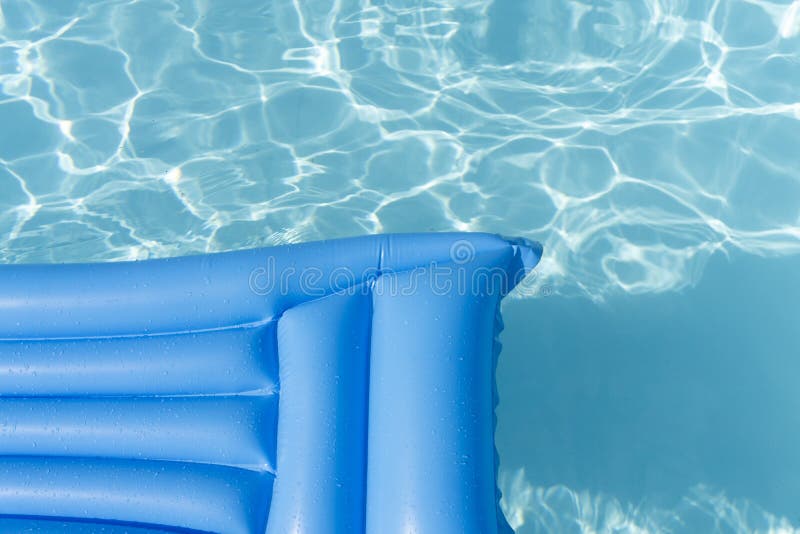 Bright Blue Summer Pool Lounger Float on a Rippled Swimming Pool Stock ...