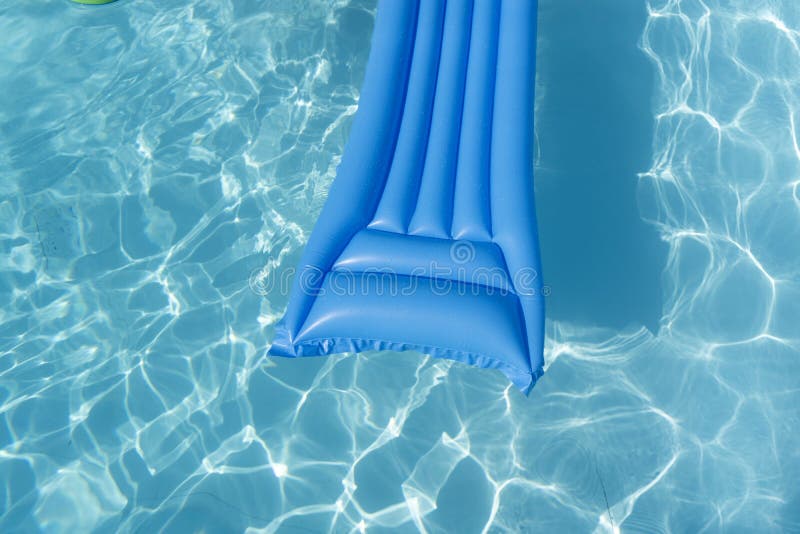 Bright Blue Summer Pool Lounger Float on a Rippled Swimming Pool Stock ...