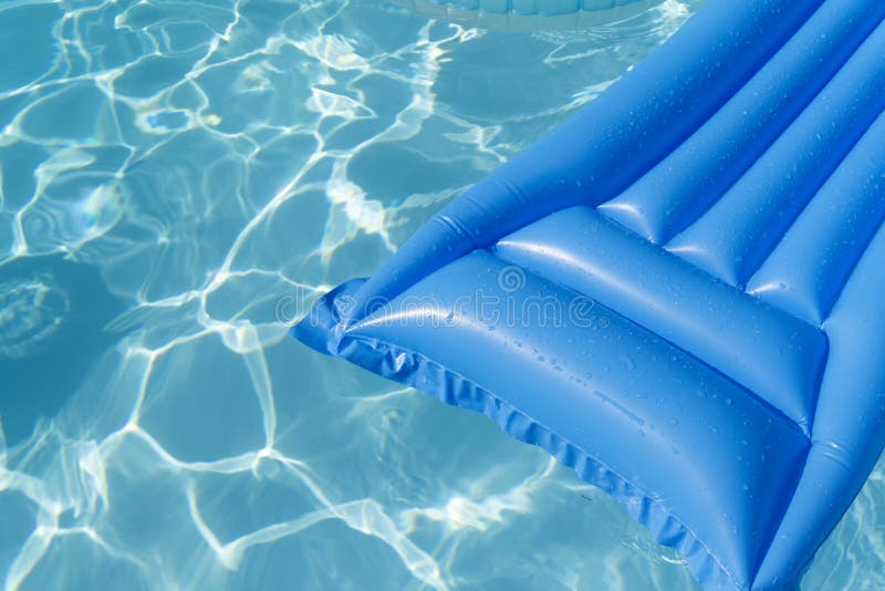 Bright Blue Summer Pool Lounger Float on a Rippled Swimming Pool Stock ...