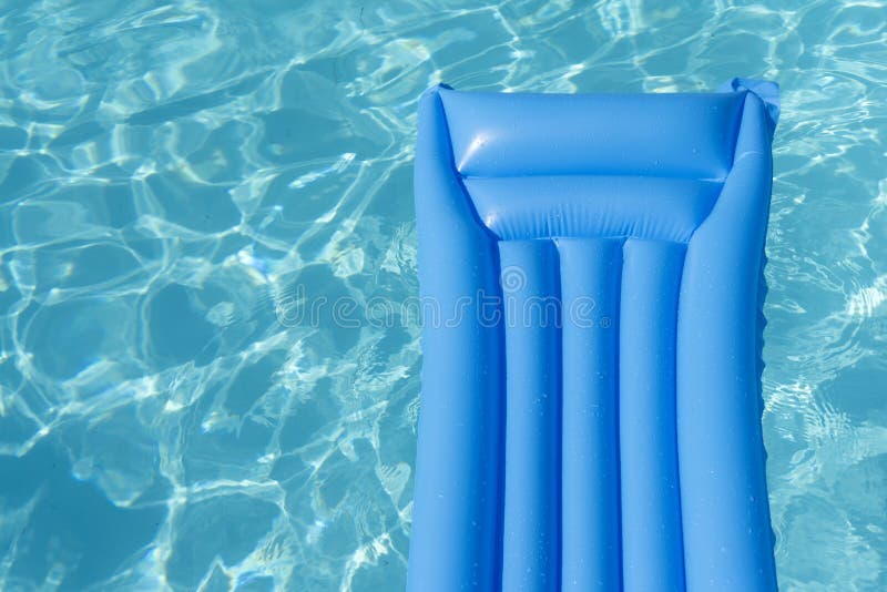 Bright Blue Summer Pool Lounger Float on a Rippled Swimming Pool Stock ...