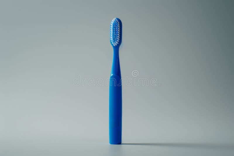 A Bright Blue Toothbrush with Soft Bristles Standing Upright Against a ...
