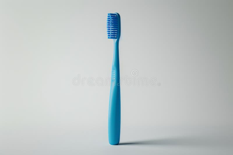 A Bright Blue Toothbrush with Soft Bristles Standing Upright Against a ...