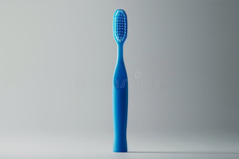 A Bright Blue Toothbrush with Soft Bristles Standing Upright Against a ...