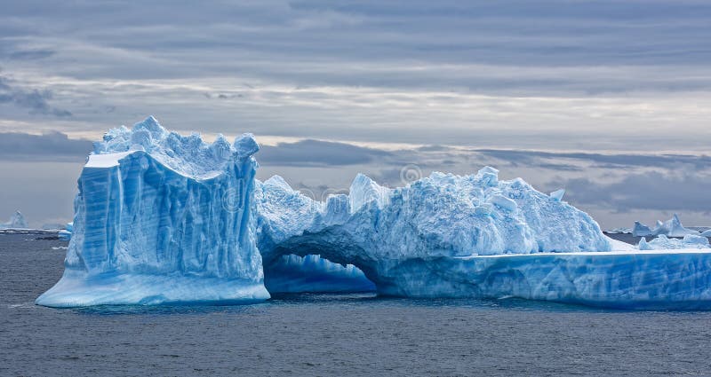 Bright Blue and Turquoise Iceberg in Grey Southpolar Ocean Stock Image ...