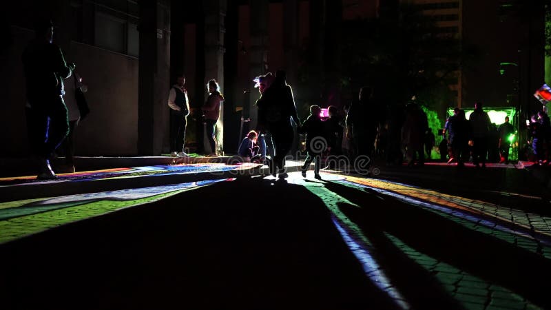 Bright Colored Rays Break through the Crowd and a Girl Dances in the ...