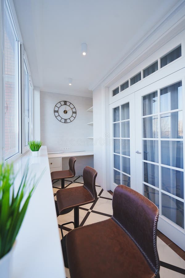 A Bright and Cozy Balcony with a Wall Clock, a Desk and a Bar. Stock ...