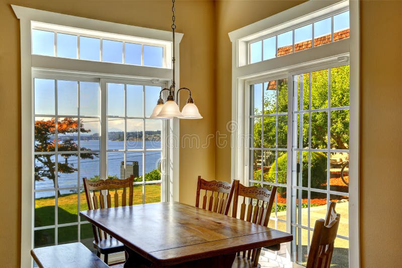 Bright Dining Area with Rustic Table and French Windows Stock Image ...