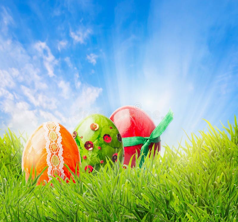 Bright Easter Egg on Grass Over Blue Sky with Sunrays Stock Image ...
