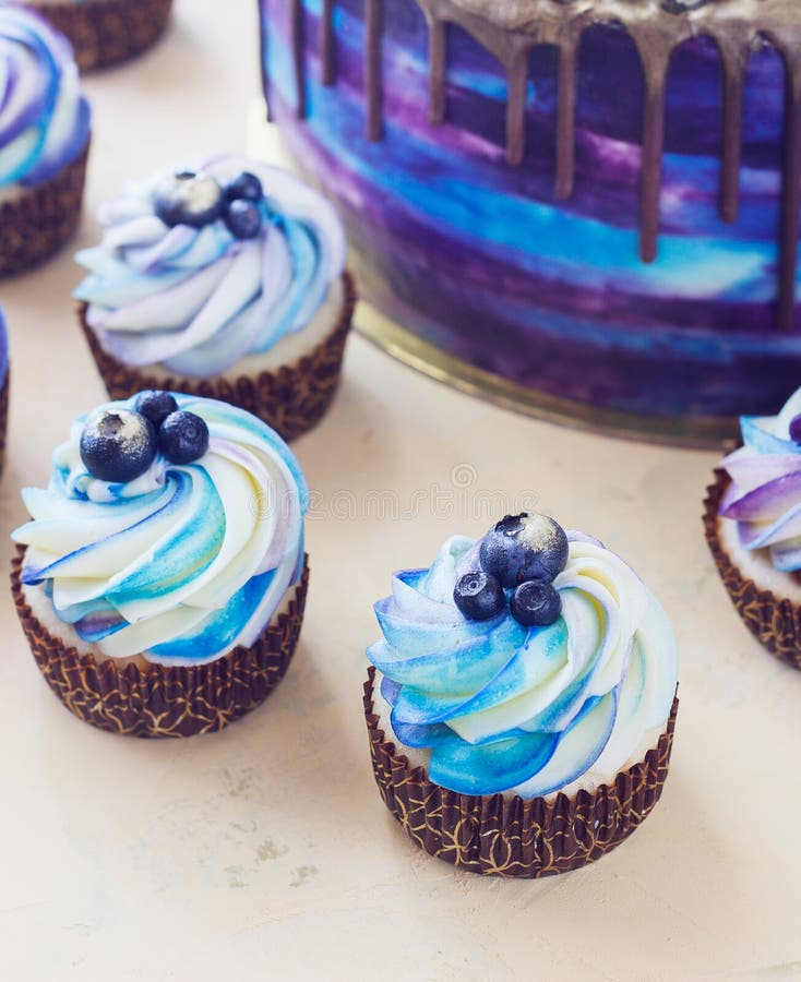 Bright Festive Blue Cake with Berries and Chocolate and Cupcakes with ...