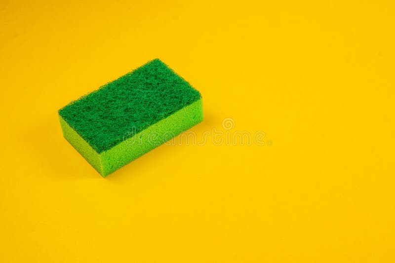 Green Cleaning Sponge on Vibrant Yellow Background Stock Image - Image ...