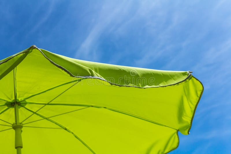Bright Green Parasol with Blue Sky Background Stock Image - Image of ...