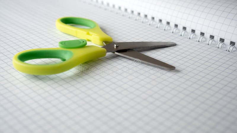 Bright Green Scissors Resting on a Checkered Notebook Page Stock Image ...