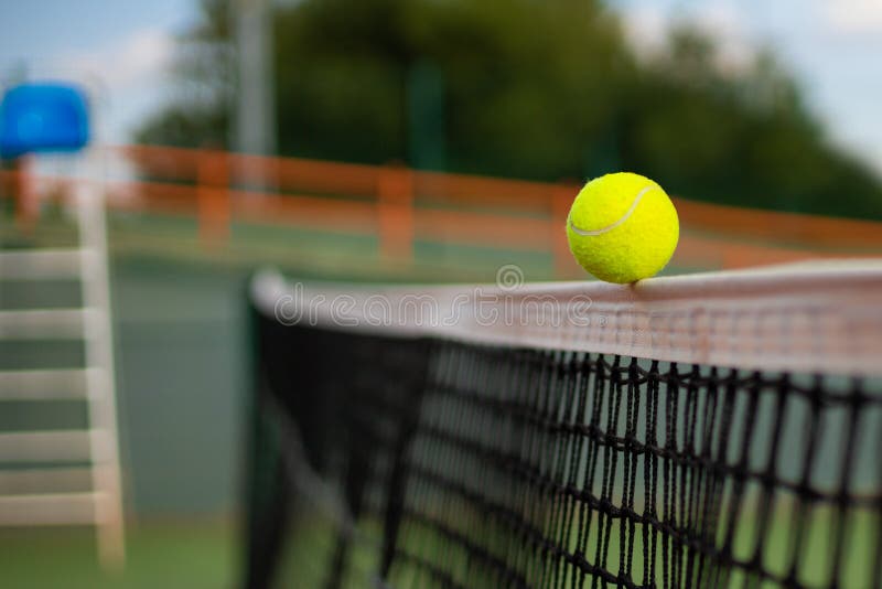 Bright Greenish Yellow Tennis Ball Hitting the Net. Stock Photo - Image ...