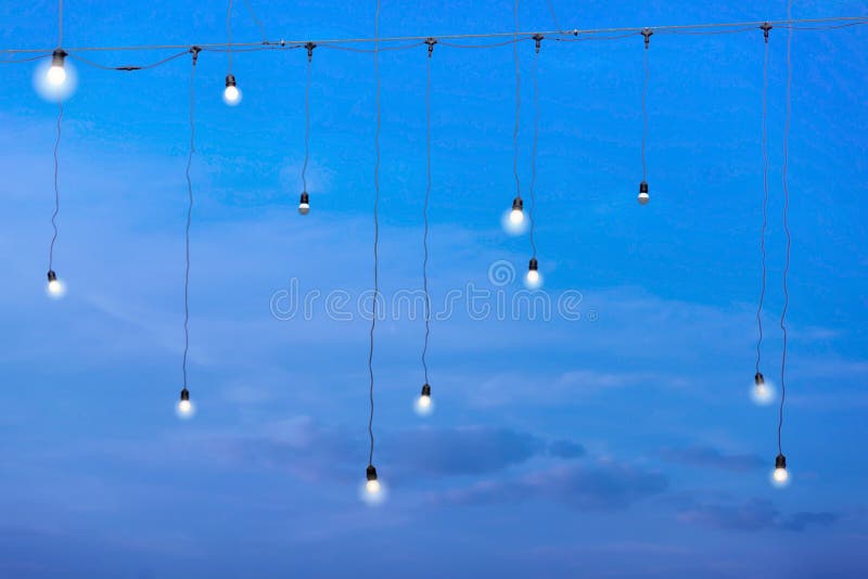 Bright Idea Concept: on and Off Light Bulbs in Front of Blue Sky Stock ...