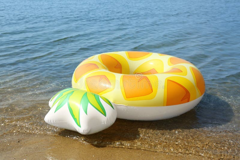 Inflatable Pineapple Floating in Sea. Close Up Shot of Rubber Ring with ...