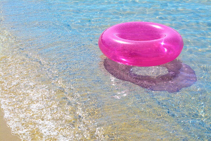 Bright Inflatable Ring on Sandy Beach Near Sea. Space for Text Stock ...