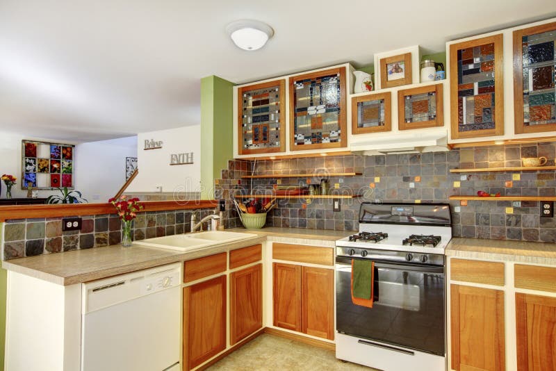 Bright Kitchen Interior with Brown Tile and Colourful Cabinets Stock ...
