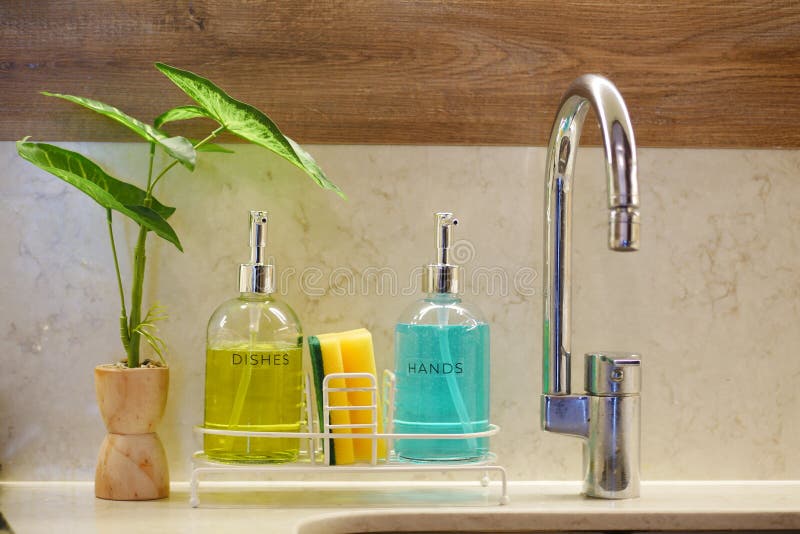 Bright Kitchen Sink with Decorative Soap Dispensers and Plant Stock ...