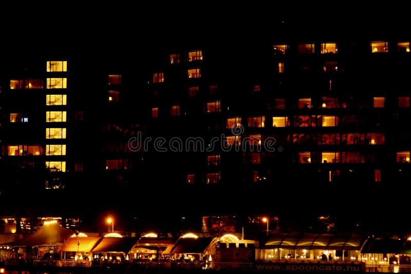 Bright Light in the Square Windows of a Multistory Building at Night in ...