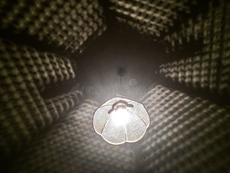 Looking Up at Glowing Lamp Hanging from the Ceiling with Shadows Stock ...