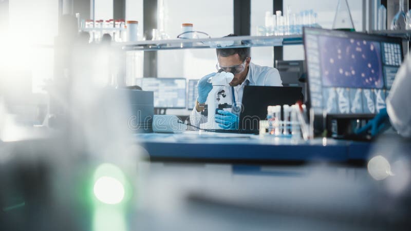 In Bright Medical Science Laboratory: Brilliant Microbiologist Looks ...