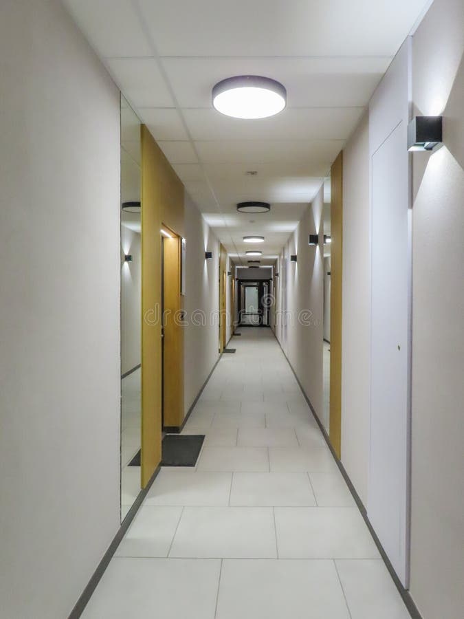 Bright Modern Corridor in Apartment Building or Hotel with Closed Doors ...