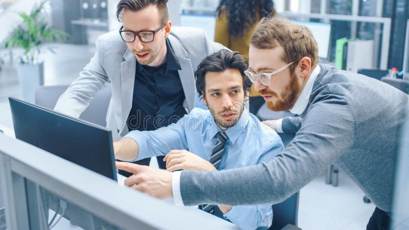 In Bright Modern Office: Businessman Sitting and Working at His Desktop ...