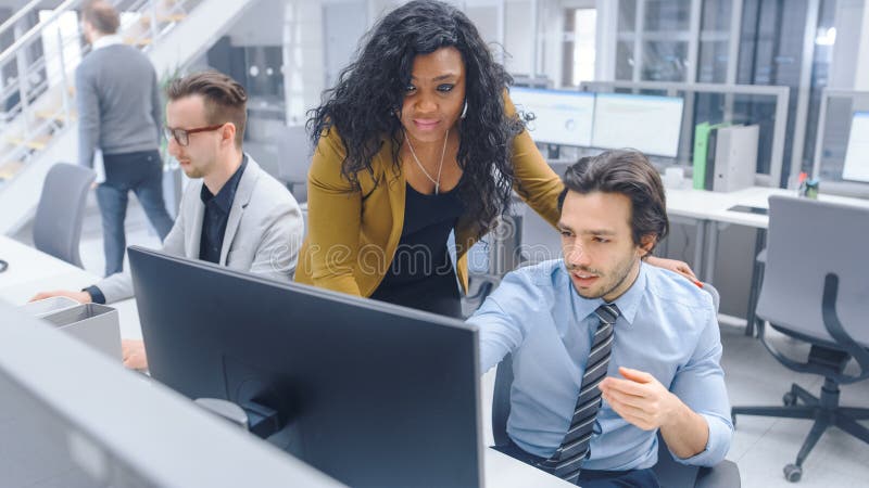 In Bright Modern Office: Handsome Office Worker Sitting and Working at His Desktop Computer ...