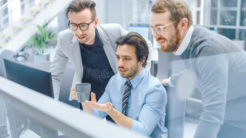 In Bright Modern Office: Office Worker Sitting and Working at His ...