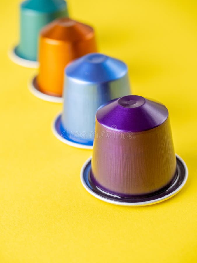 Bright Multi-colored Coffee Capsules for the Coffee Machine on a Yellow ...