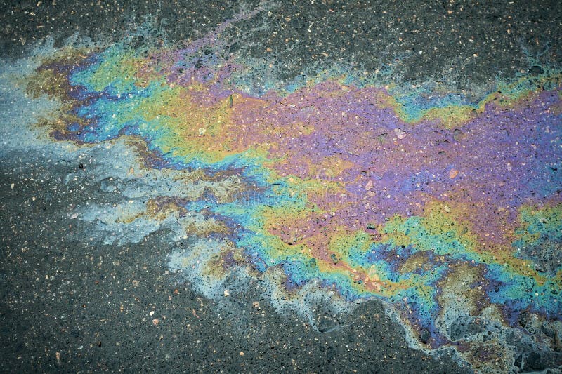 Bright Oil Slick Creates Iridescent Patterns on Asphalt after a ...