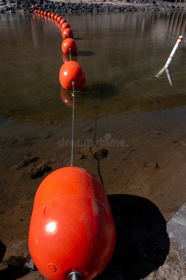 Bright Orange Buoy in the Water Behind a Dam Stock Photo - Image of ...