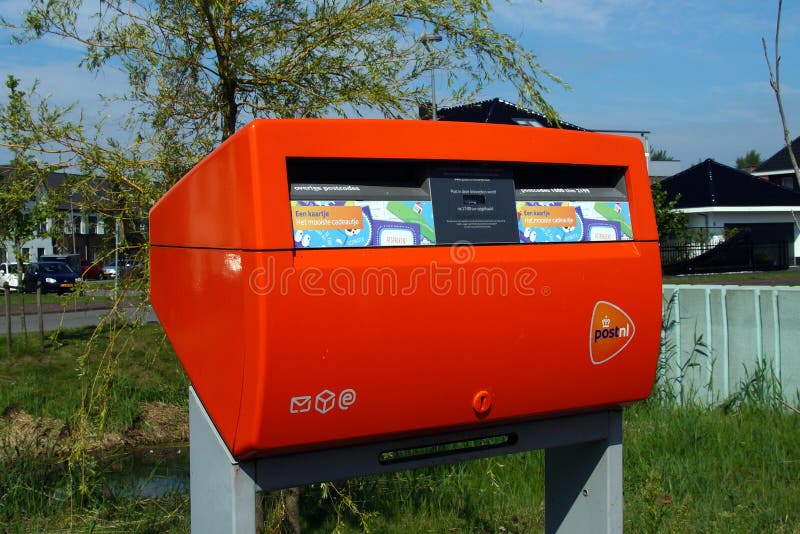 Orange PostNL mailbox editorial stock image. Image of delivery - 94137724