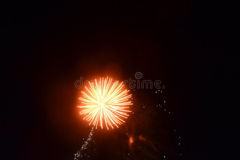 Bright Orange Firework Shoots into the Sky Bursting Light Illuminates ...