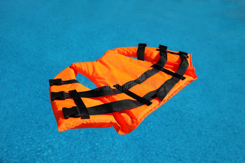 Bright Orange Life Jacket Floating in Swimming Pool Stock Photo - Image ...