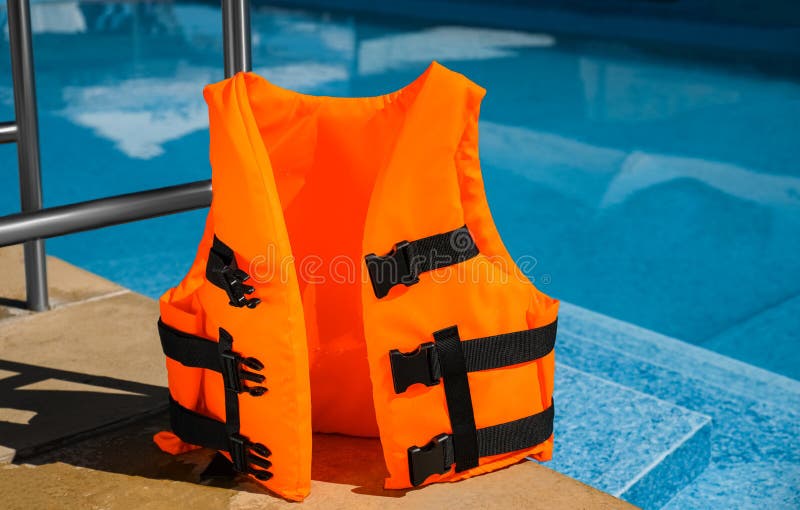 Bright Orange Life Jacket Near Swimming Pool Stock Photo - Image of ...