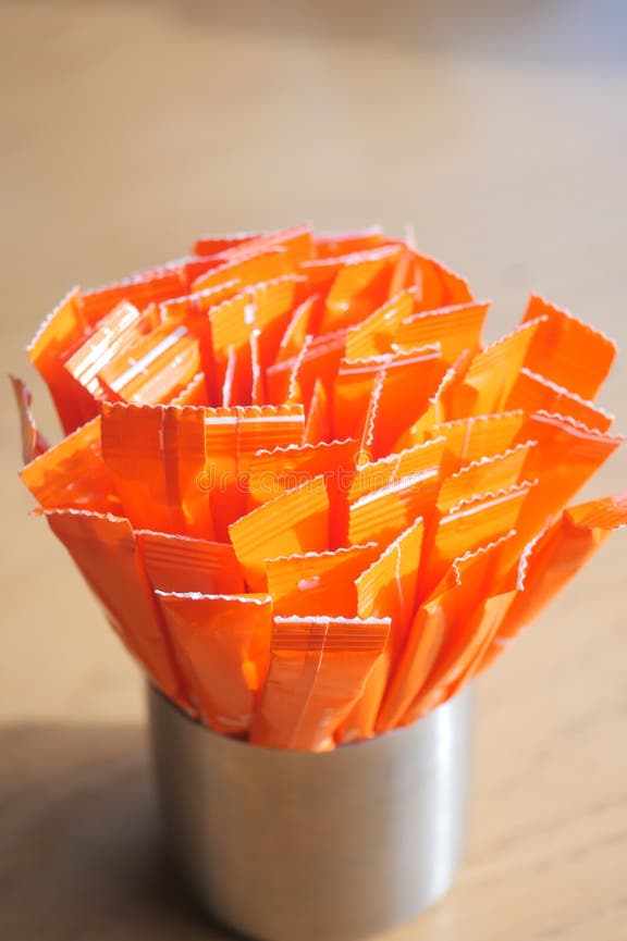 Bright Orange Sugar Packets Arranged in a Holder Stock Photo - Image of ...