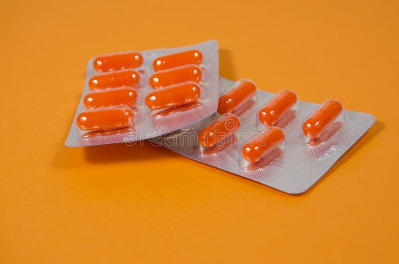 Bright Orange Tablets in Silver Packaging on an Orange Background Stock ...