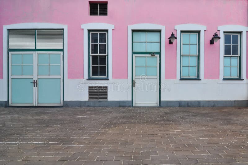 Bright Pink Wall with Doors and Windows Invites Exploration in a ...