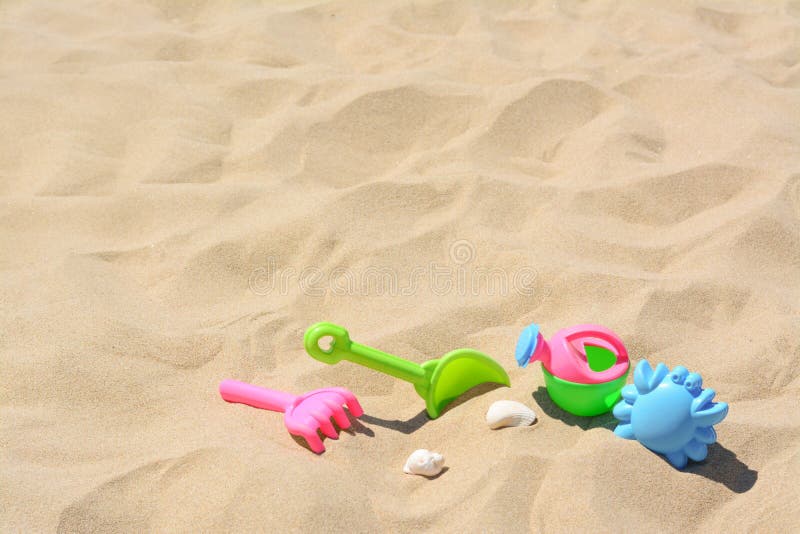 Bright Plastic Rake and Shovel on Sand. Beach Toys. Space for Text ...
