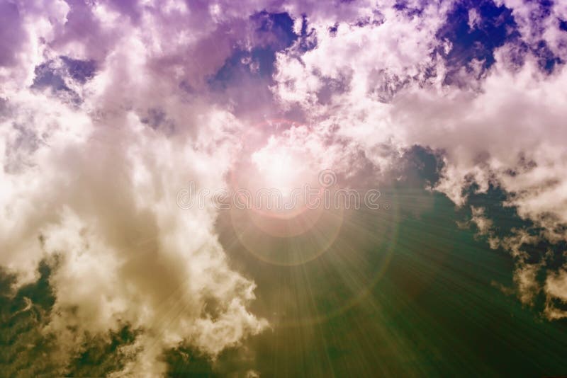 A Bright Ray of Sunshine Breaks through the Fluffy White Clouds. the ...