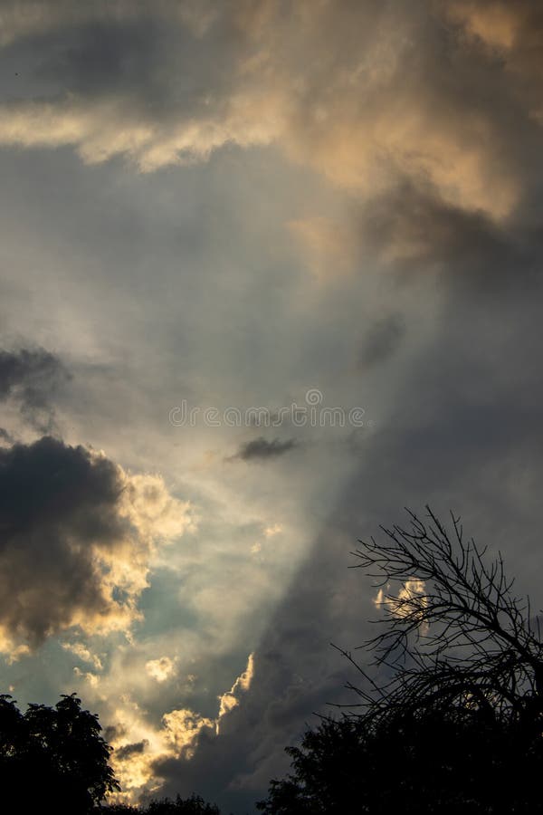 Bright Rays of Sun Break through Dark Clouds Stock Photo - Image of ...